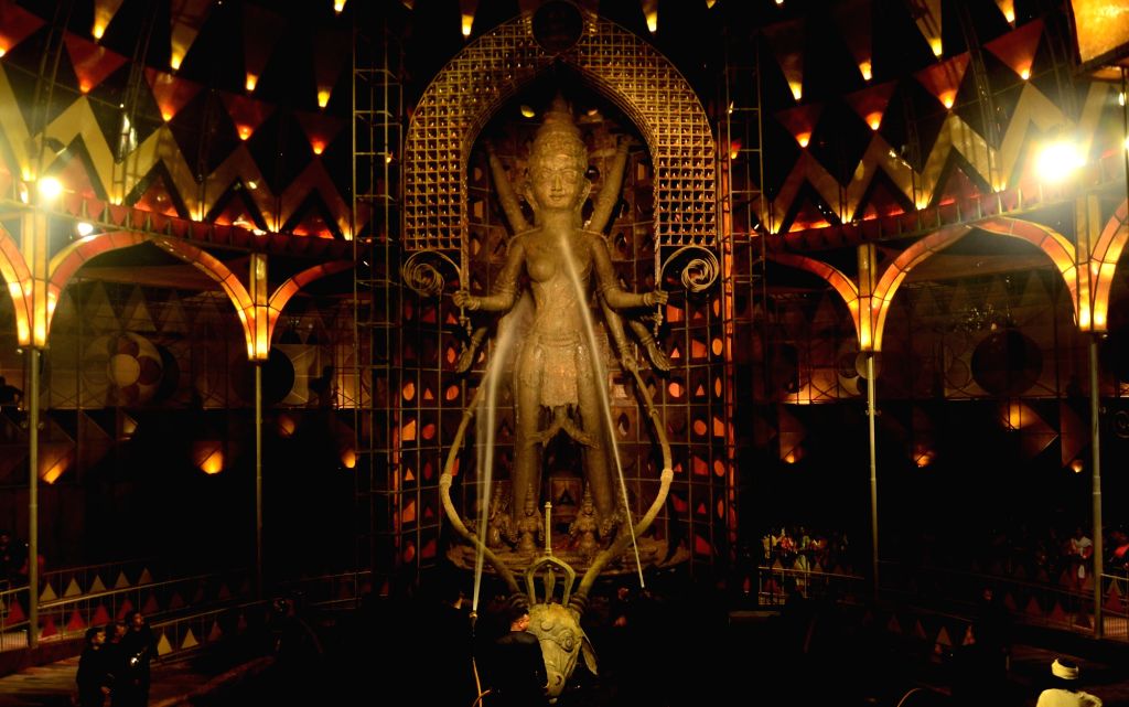 An idol of Goddess of Durga immersed by water from a water hose pipe
