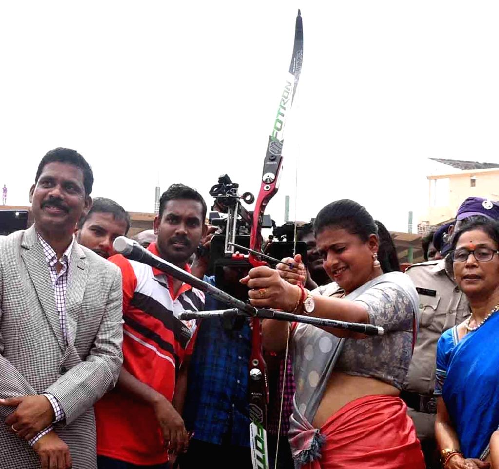 Andhra Pradesh Minister RK Roja plays archery during summer sports camp