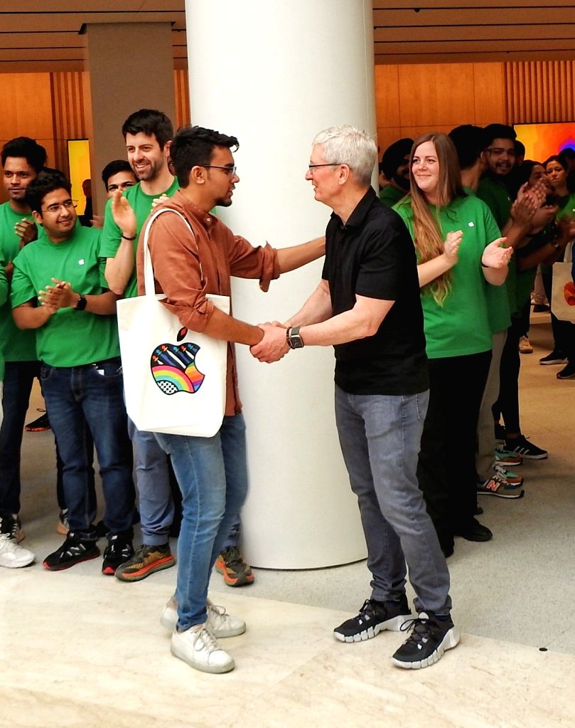 New Delhi : Apple CEO Tim Cook interacts with people at the opening of ...