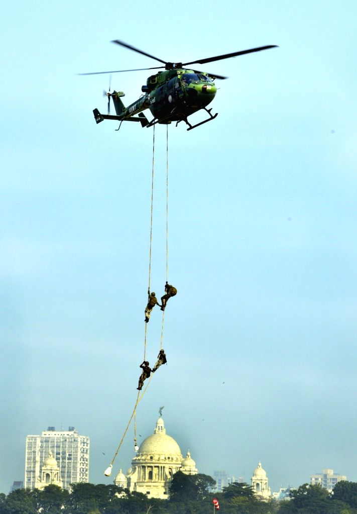 Army personnel in a chopper display their skill at the rehearsal
