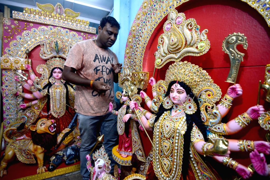 Artist Koushik Ghosh gives finishing touches to an idol of Goddess ...
