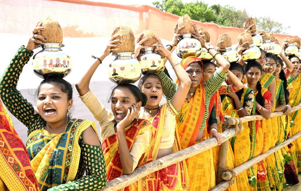 Atkot : Women holds pot decorated with Prime Minister Narendra Modi's ...