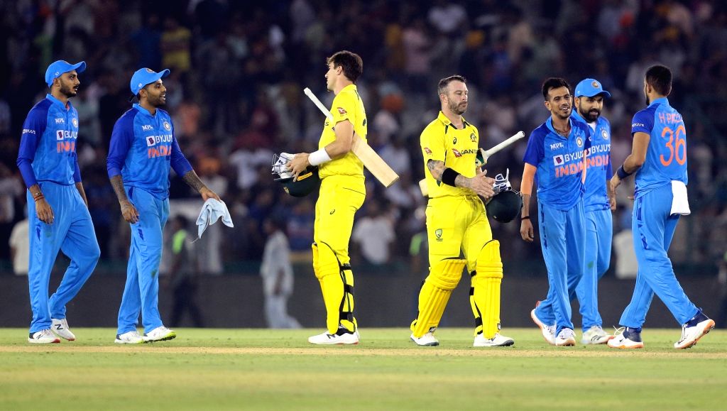 :Mohali: Australian batsman Matthew Wade and Patrick Cummins celebrate ...