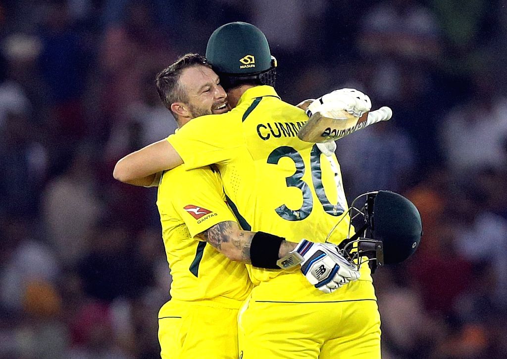 :Mohali: Australian batsman Matthew Wade and Patrick Cummins celebrate ...
