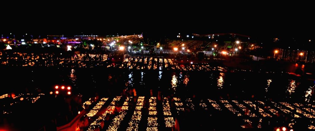 :Ayodhya:Devotees light earthen lamps on the bank of river Saryu during ...