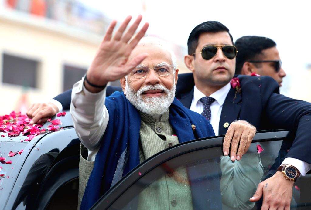 Ayodhya : Prime Minister Narendra Modi waves toward supporters during a ...