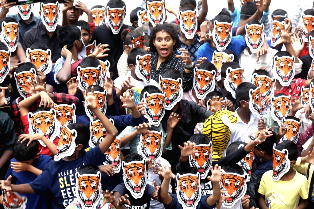 Bengaluru : Underprivileged children wearing tiger face masks take part ...
