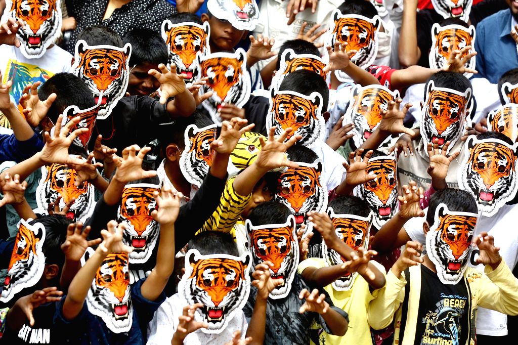 Bengaluru : Underprivileged children wearing tiger face masks take part ...