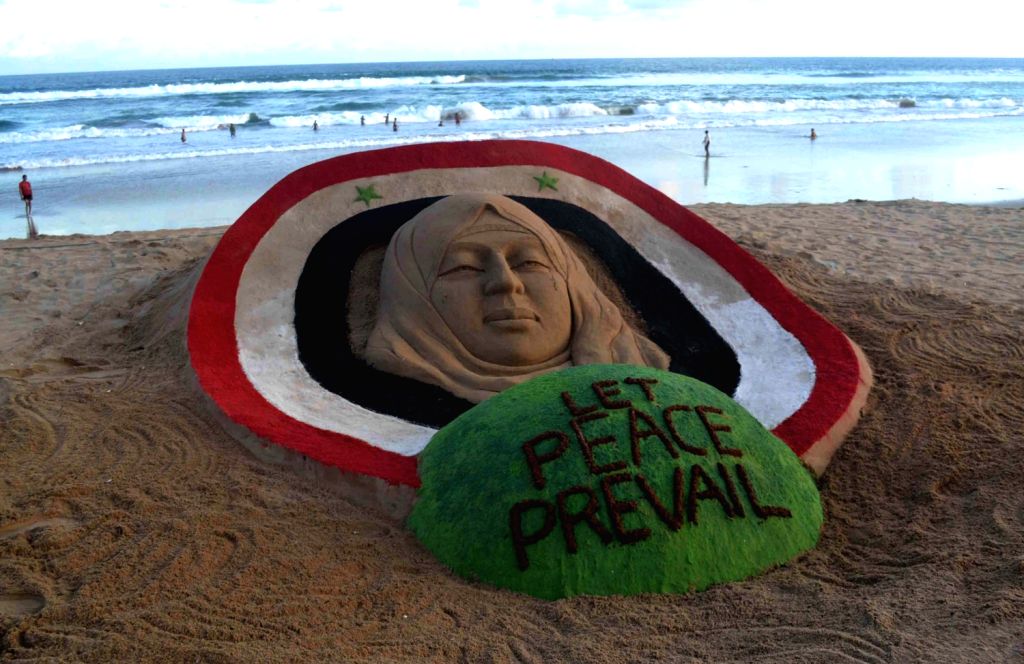 Sand artist Sudarshan Pattnaik's sand sculpture of peace in Syria