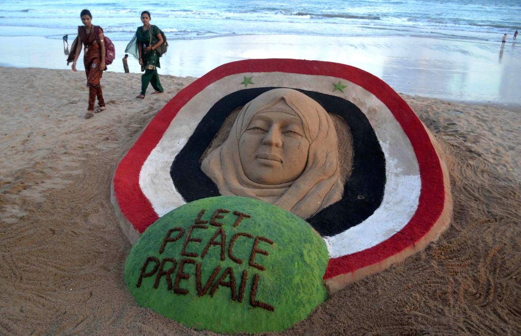 Sand artist Sudarshan Pattnaik's sand sculpture of peace in Syria
