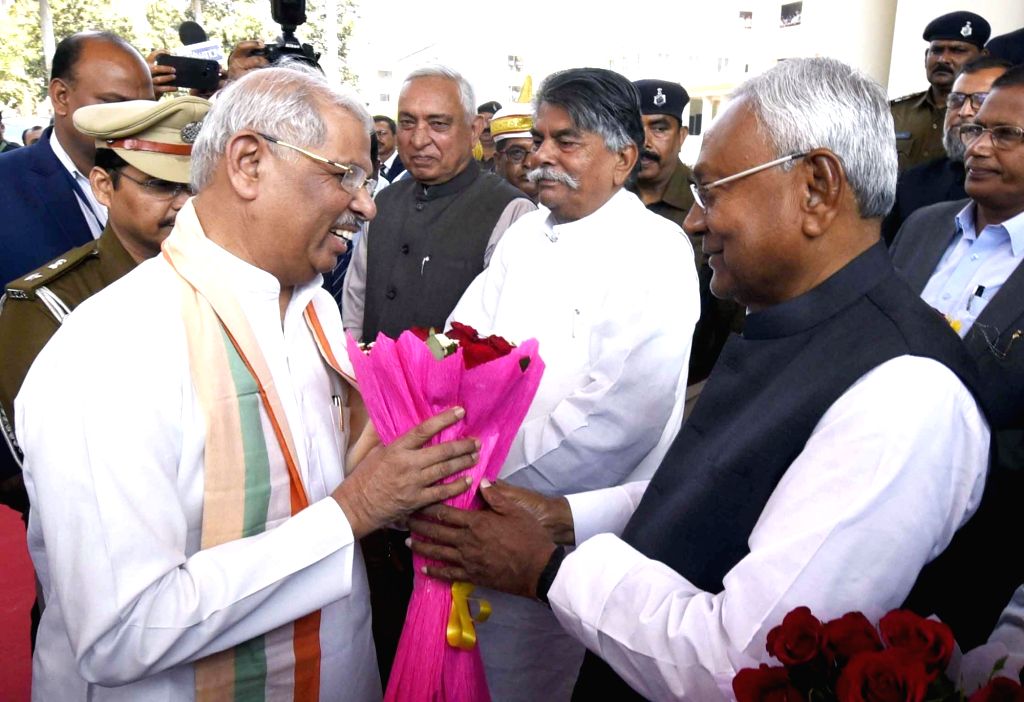 Bihar Chief Minister Nitish Kumar presents a bouquet to Governor ...