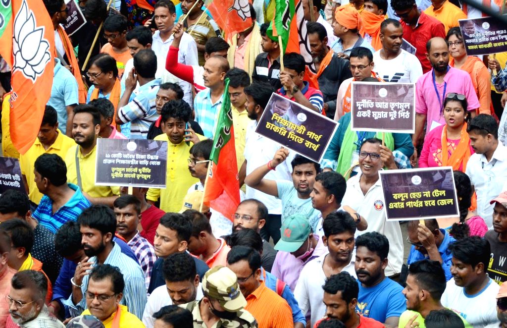 BJP activists take part in a protest rally against TMC leader Partha ...