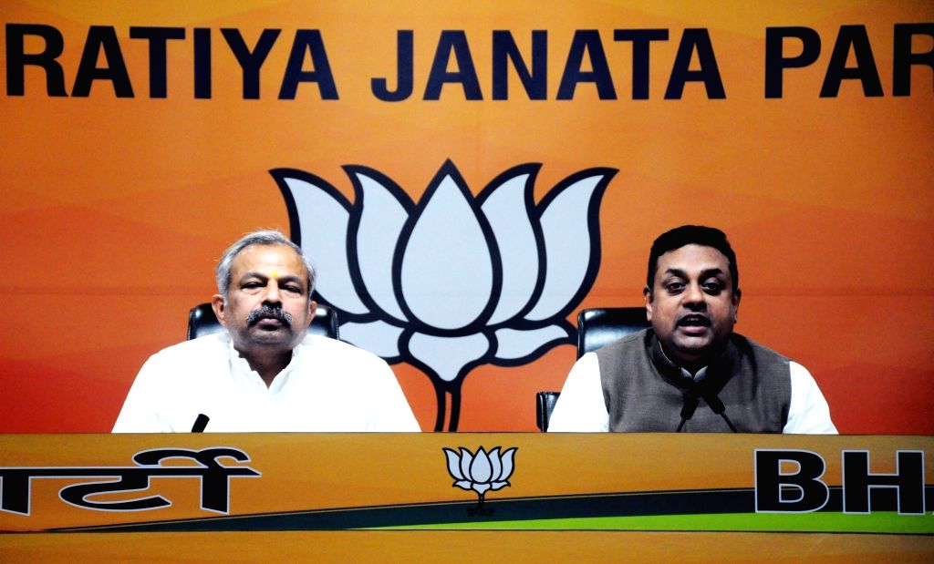 BJP leader Sambit Patra along with party Delhi president Adesh Gupta ...