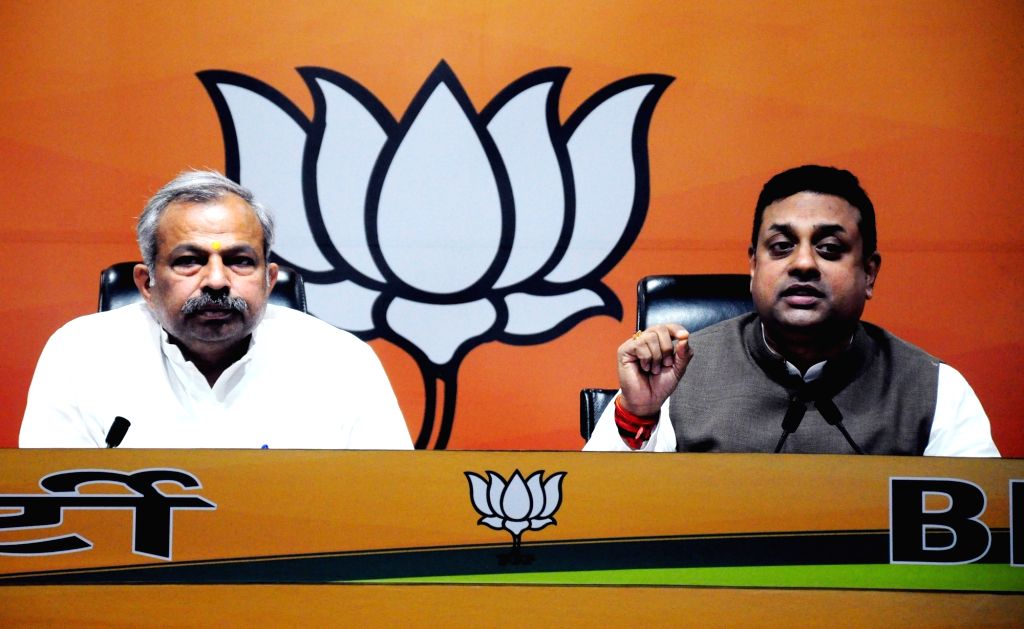 BJP leader Sambit Patra along with party Delhi president Adesh Gupta ...