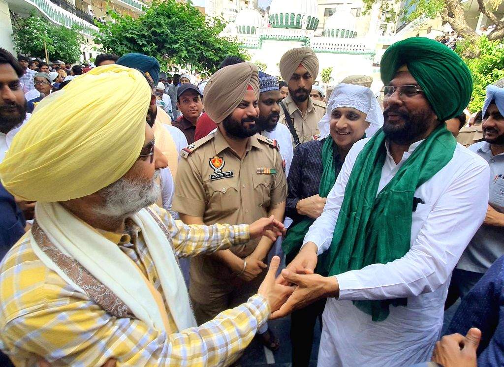 BJP leader Taranjit Singh Sandhu with AAP leader Kuldeep Singh Dhaliwal ...