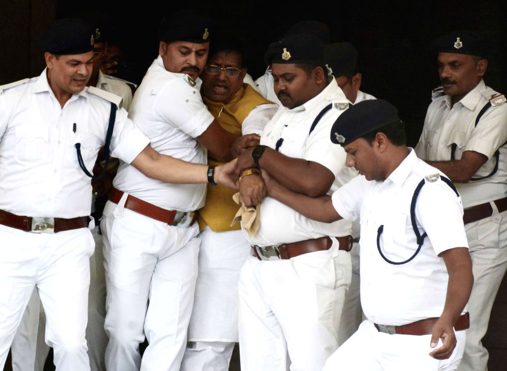 BJP legislator Shailendra being marshaled out of the Bihar Assembly