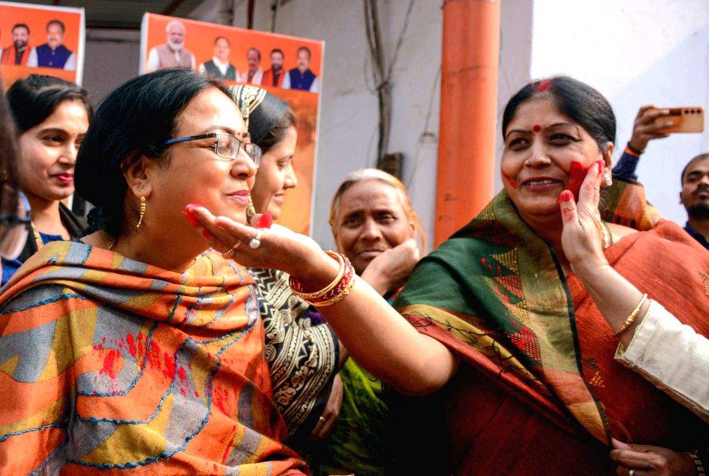 BJP supporters celebrate the NDA's victory in the by-elections
