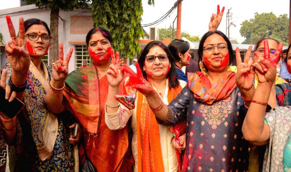 BJP supporters celebrate the NDA's victory in the by-elections