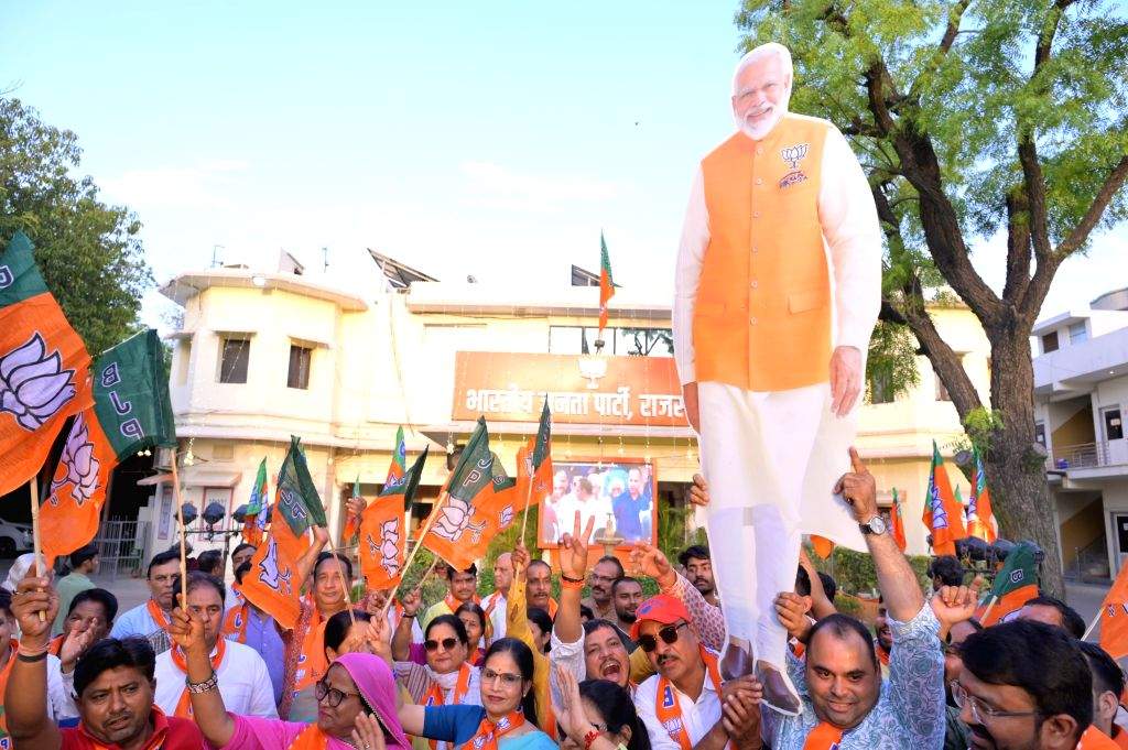 BJP workers celebrate as Prime Minister Narendra Modi becomes Prime ...