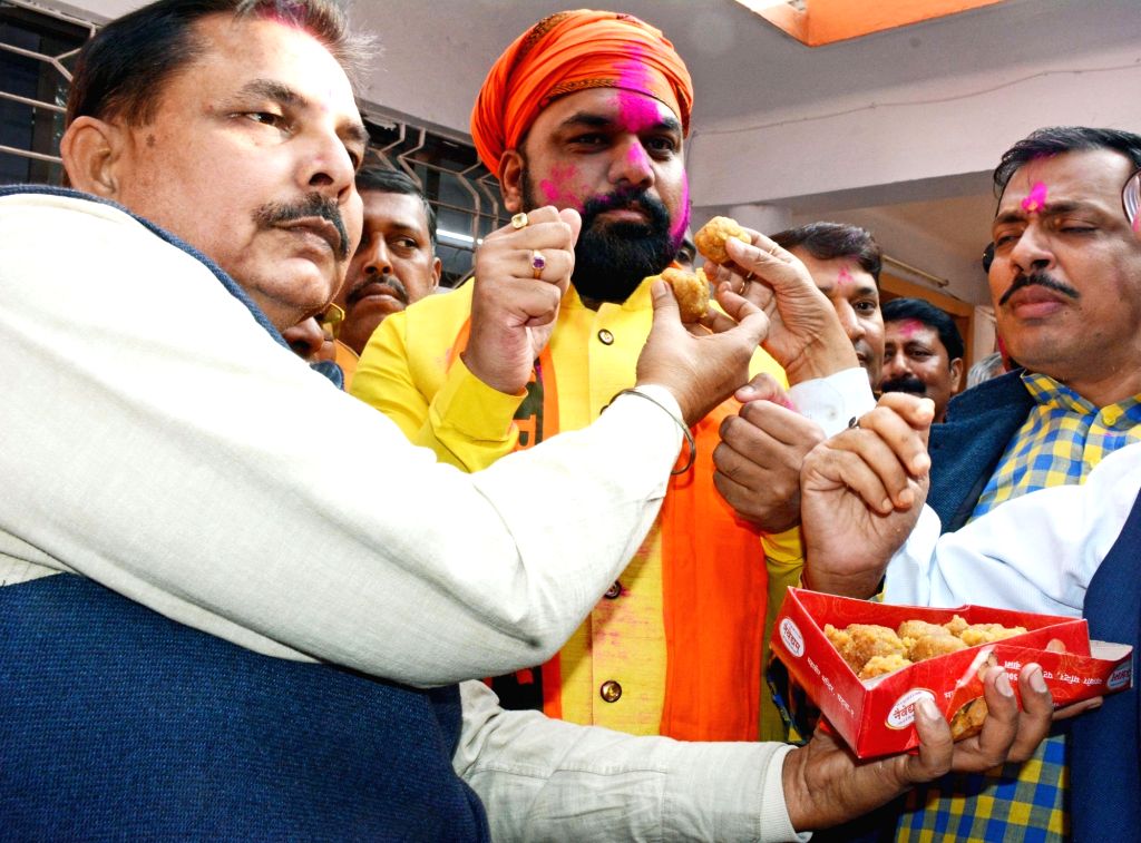 BJP workers celebrate party candidate Kedar Gupta's victory in Kurhani ...