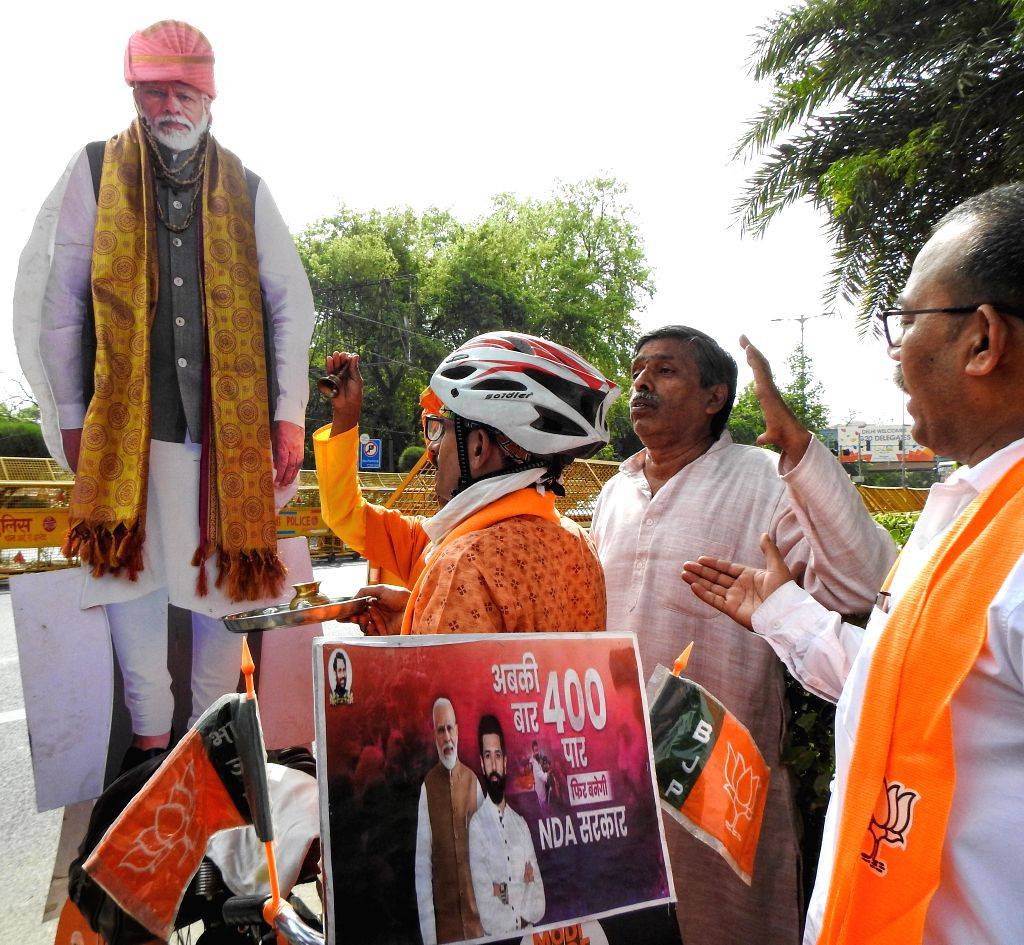 BJP workers celebrate the party's lead during the counting of votes for ...