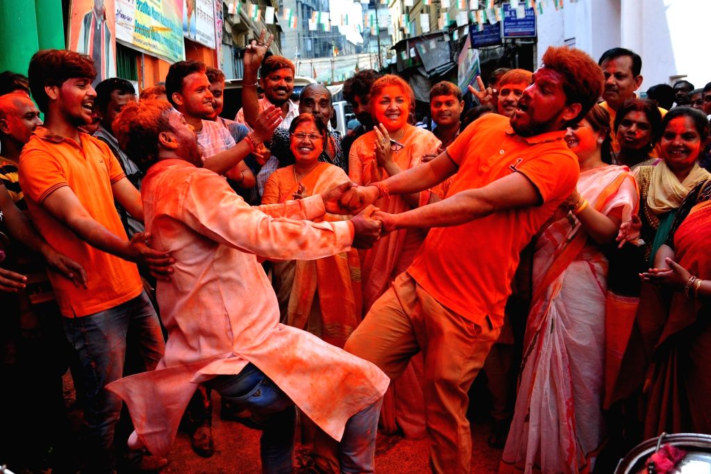BJP workers celebrate the party's performance in the recently concluded ...
