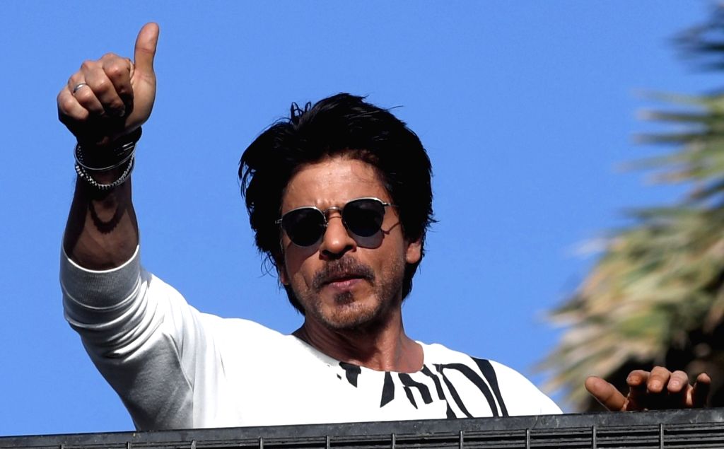 :Mumbai: Bollywood actor Shahrukh Khan poses after his fans make a ...