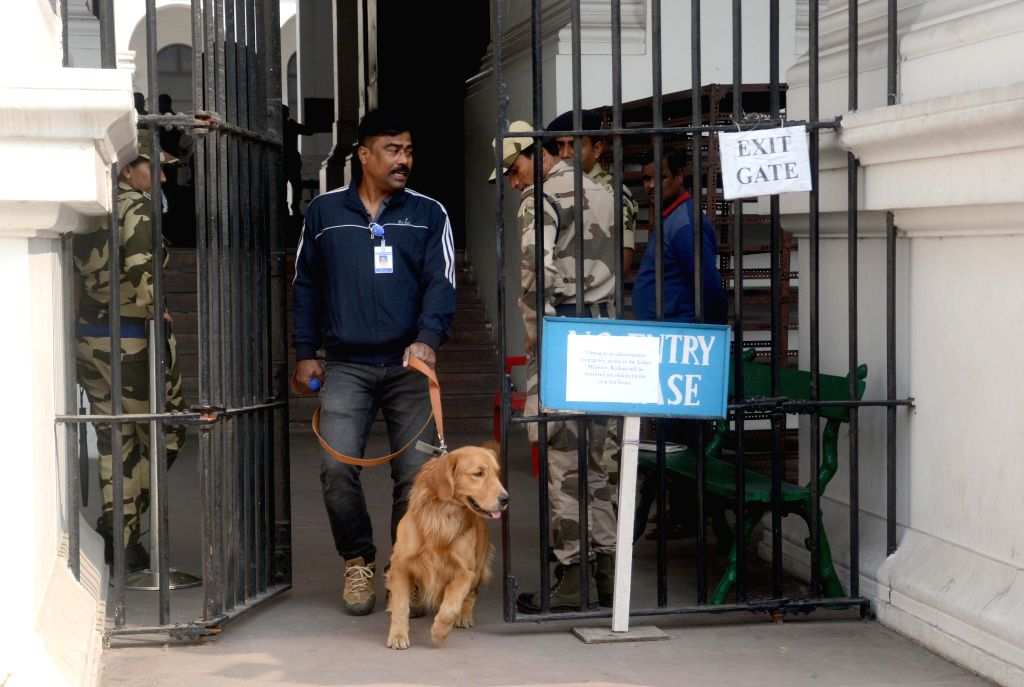 Bomb disposal squad personnel with sniffer dogs conduct a search at the ...