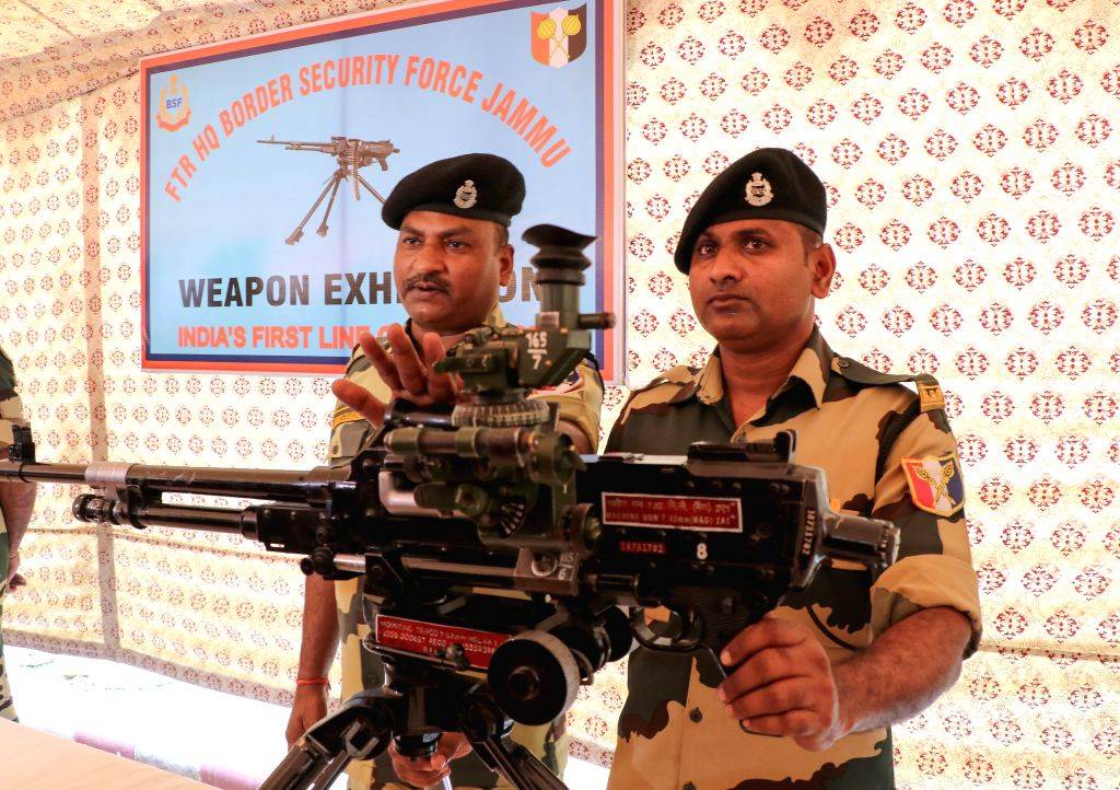 Border Security Force (BSF) personnel display weapons during an exhibition