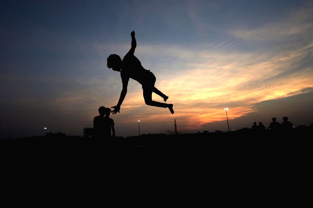 Boys practice Acrobatic stunts on the shores of the Chennai Marina Beach