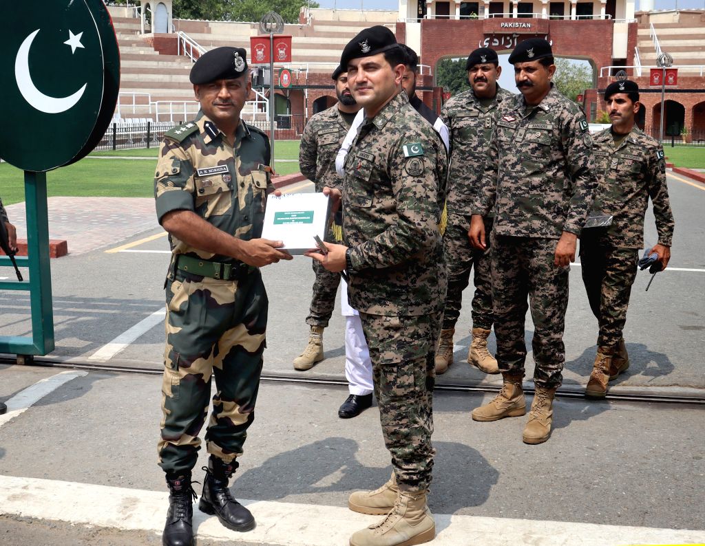 BSF personnel and Pakistani Rangers personnel exchange sweets on the ...