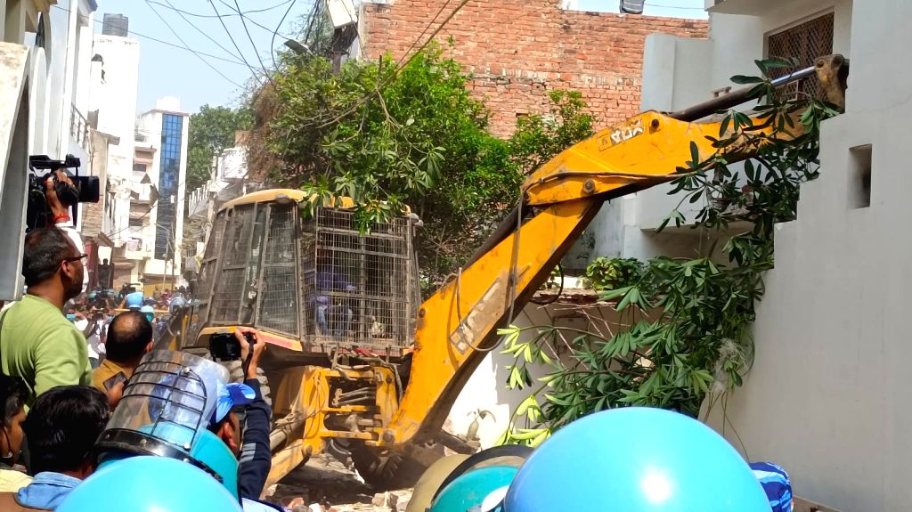 Free Photo : Bulldozer running at the house of Atiq Ahmed's close friend.