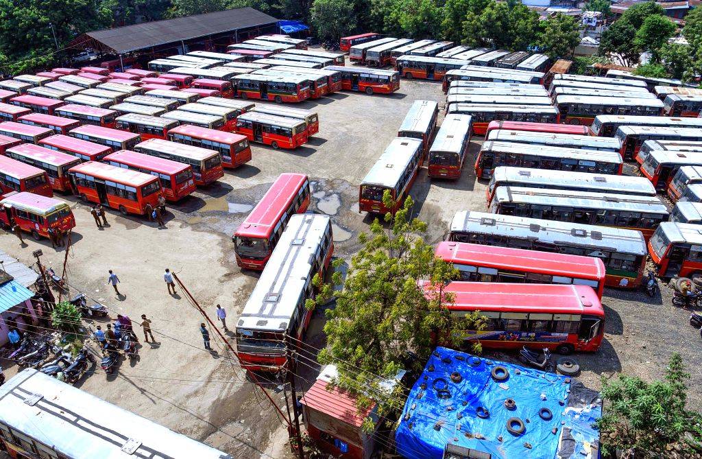 Buses remain parked at a stand as workers aligned with the Bharatiya ...