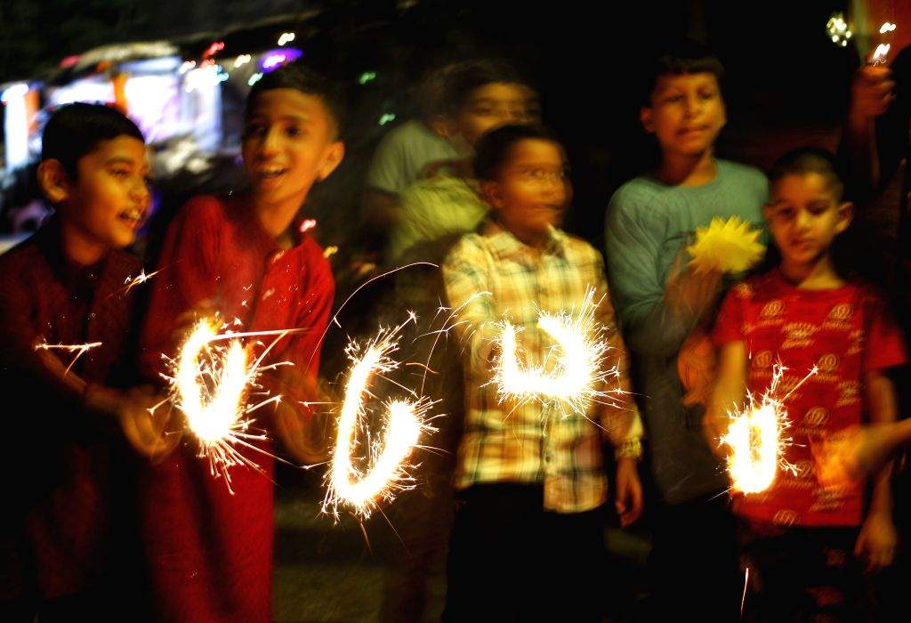 Children burst firecrackers during Diwali celebrations in New Delhi