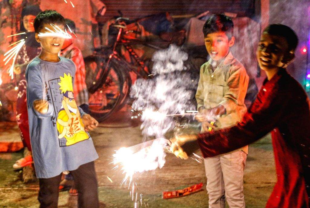 Children burst firecrackers during Diwali celebrations in New Delhi