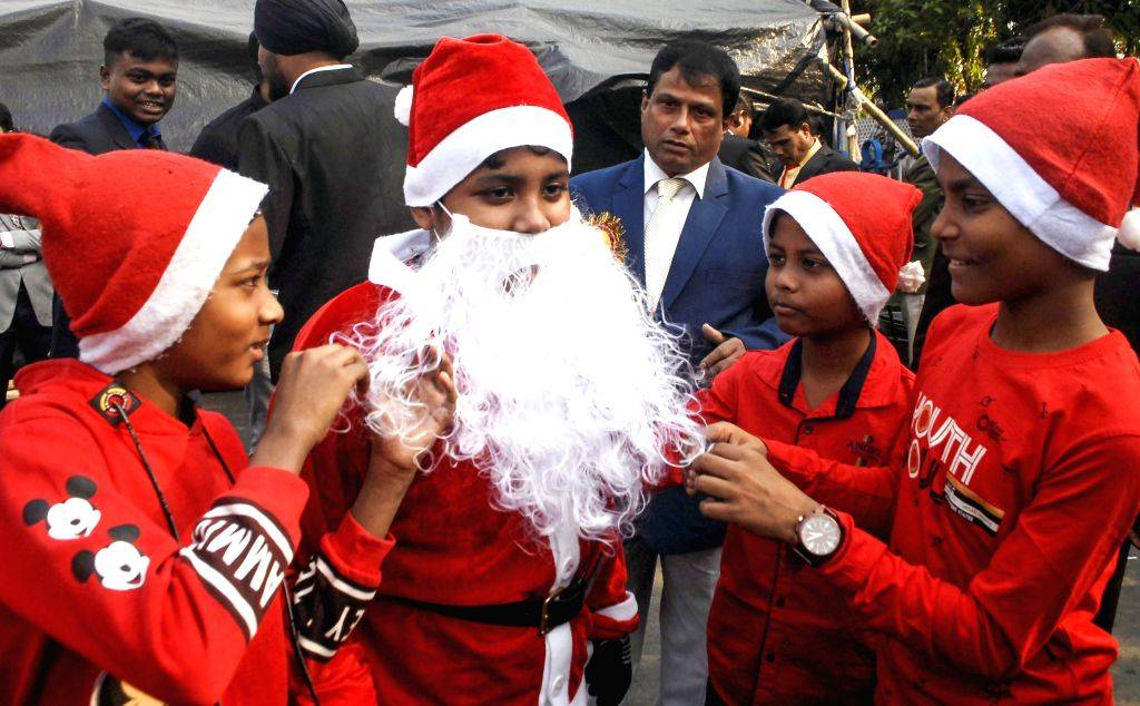 Children dressed as Santa Claus during a pre-Christmas event
