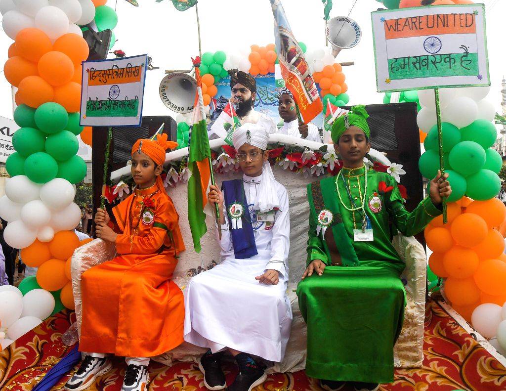 Children dressed in tricolor take part in a religious procession on the ...