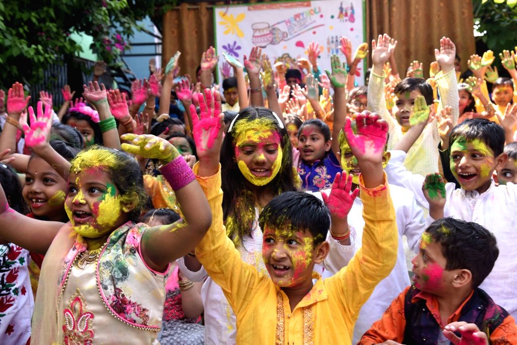 Children play with colour during the Holi celebrations