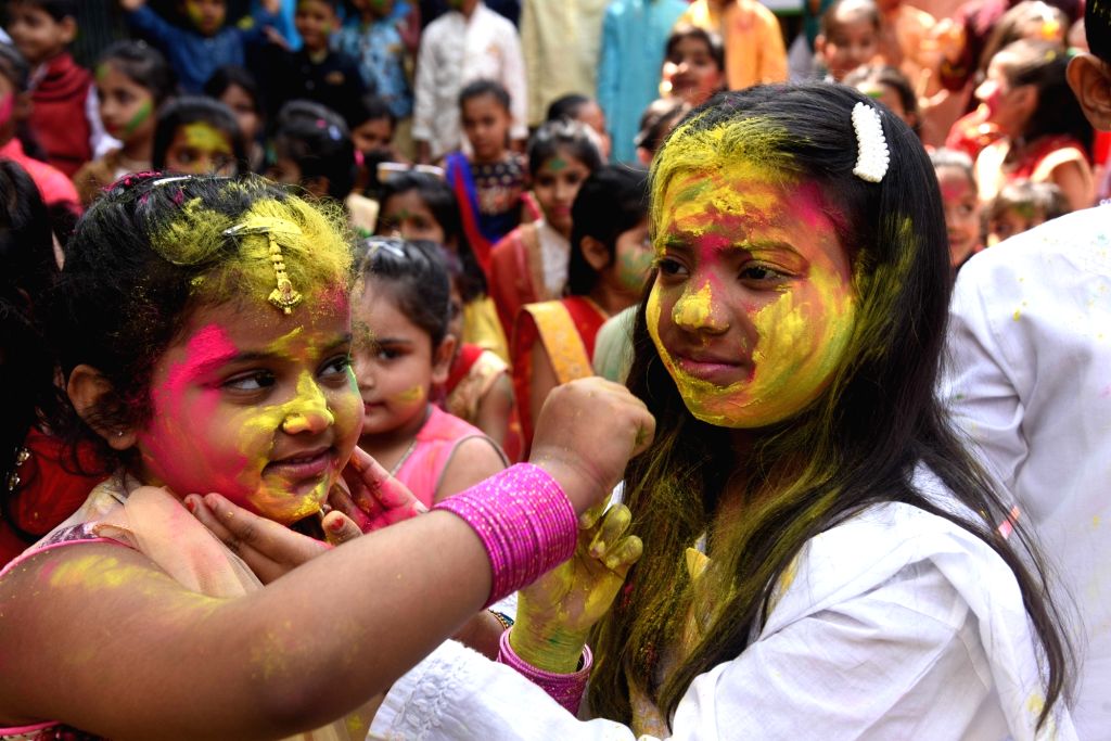 Children play with colour during the Holi celebrations