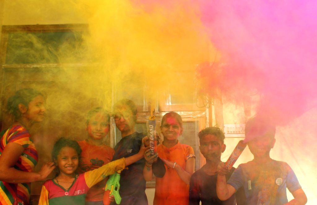Children play with colours on Holi in Gurugram on March 2, 2018.