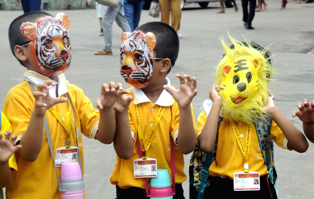 Children wearing face masks and dressed like tigers on International ...