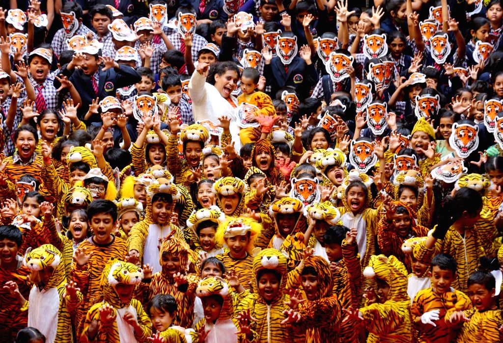 Children wearing tiger costumes participate in an awareness programme ...