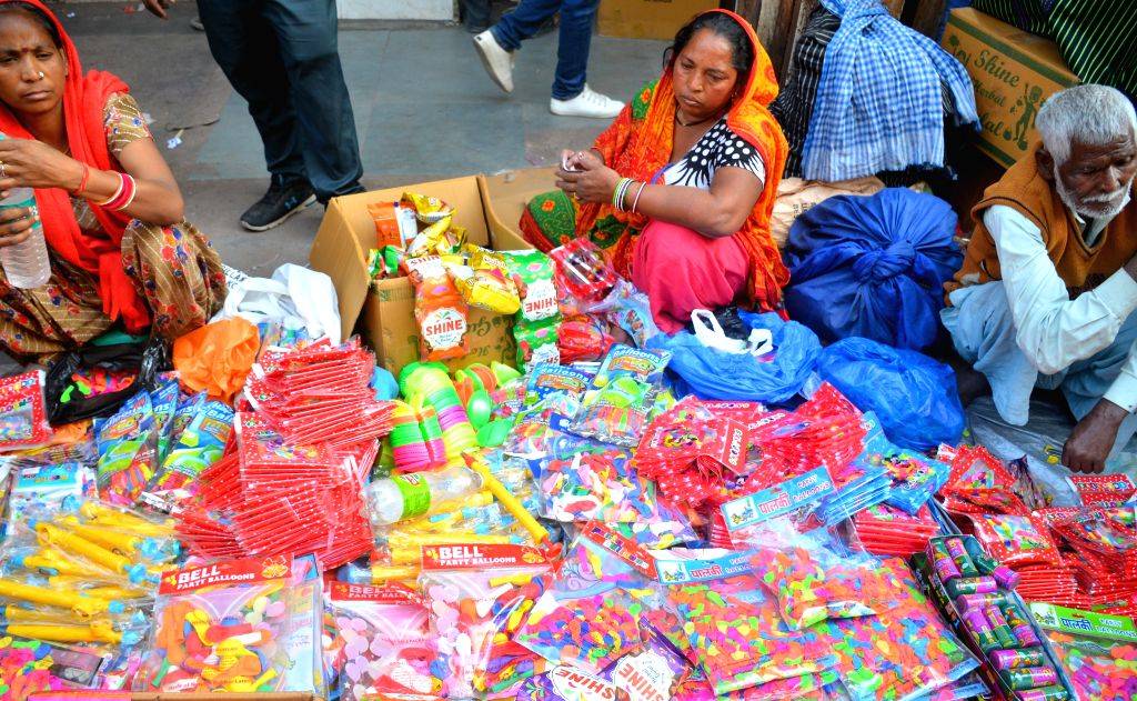Colorful items are being sold at a shop ahead of the Holi festival at ...