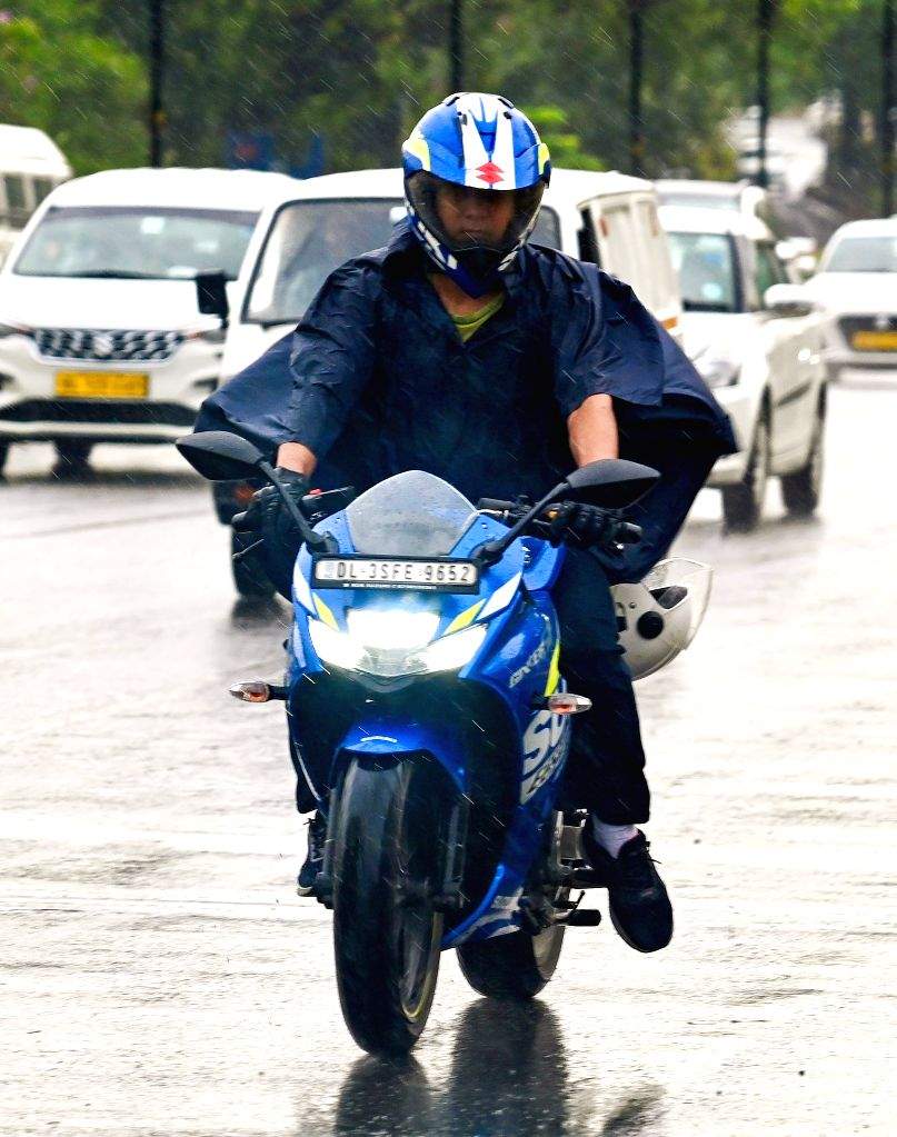 Commuters Make Their Way Amid Rain
