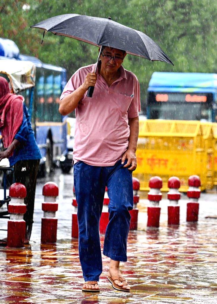 Commuters Make Their Way Amid Rain