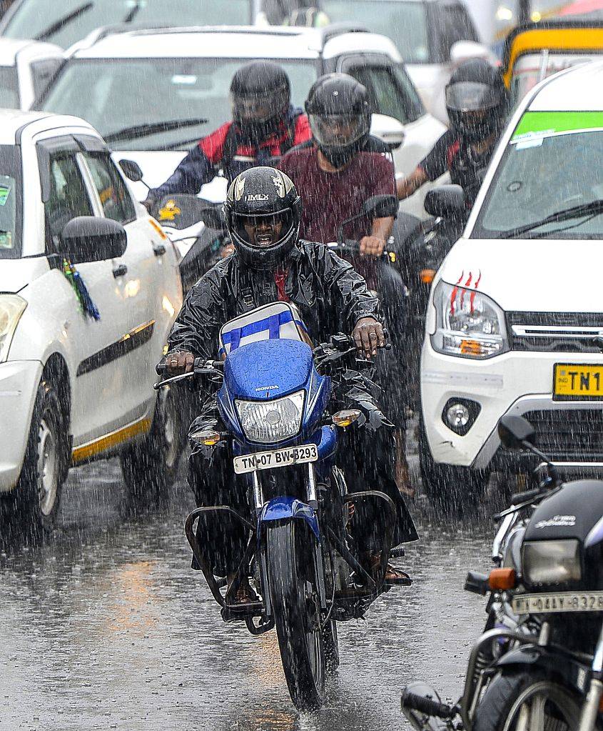 Commuters move amid rain lash in the city