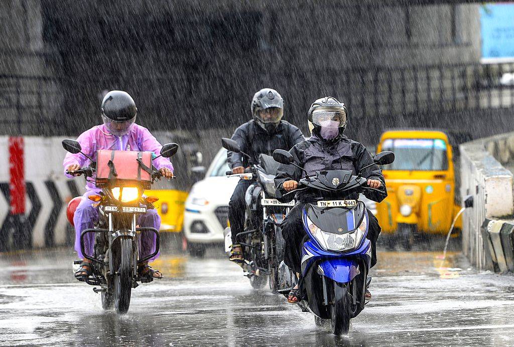 Commuters move amid rain lash in the city