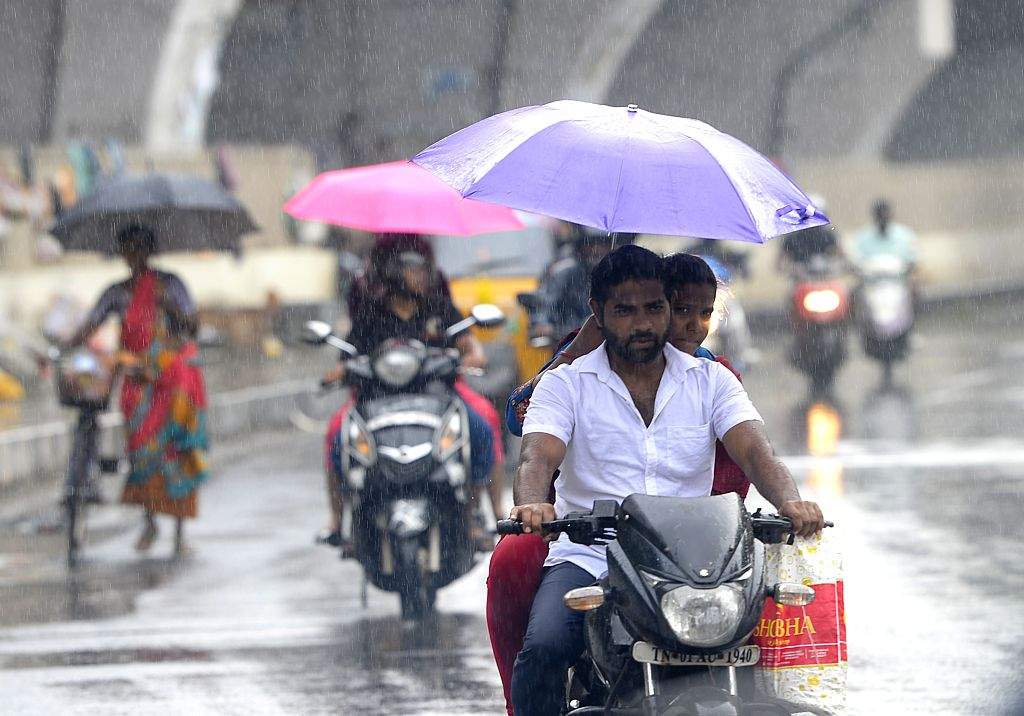 Commuters move amid rain lash in the city