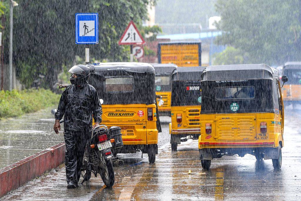 Commuters move amid rain lash in the city