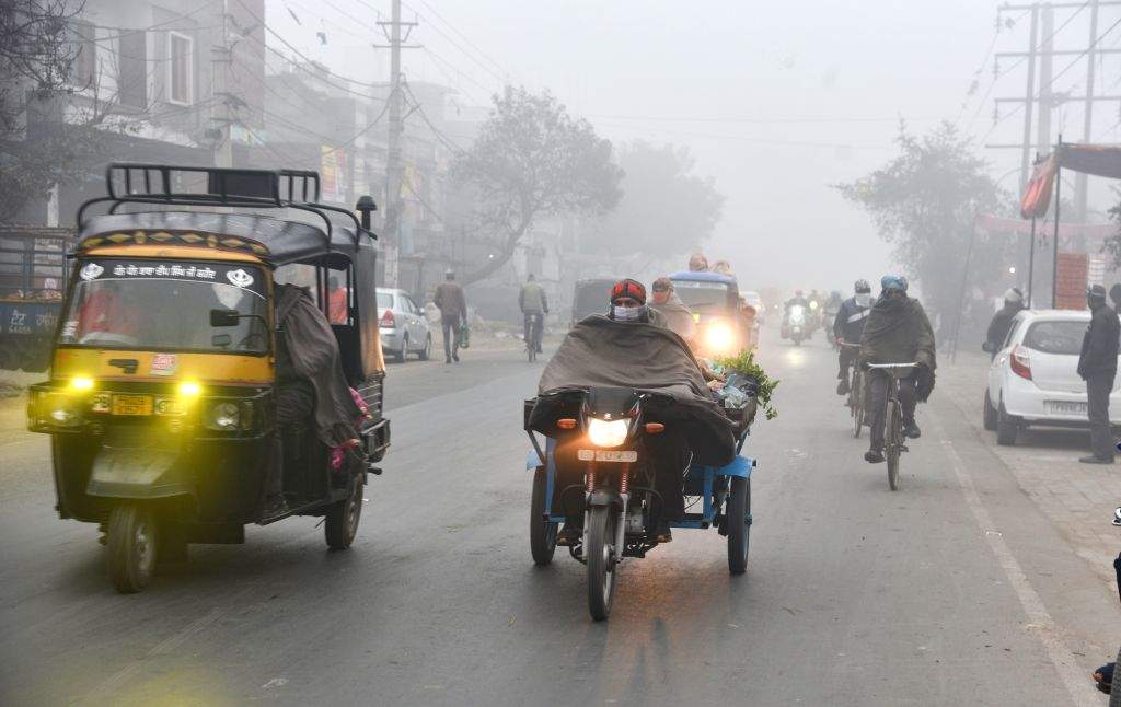 Commuters Ride Through Dense Fog